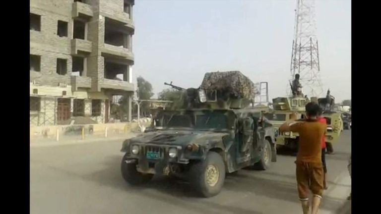 ISIS militants parade through the city of Baiji