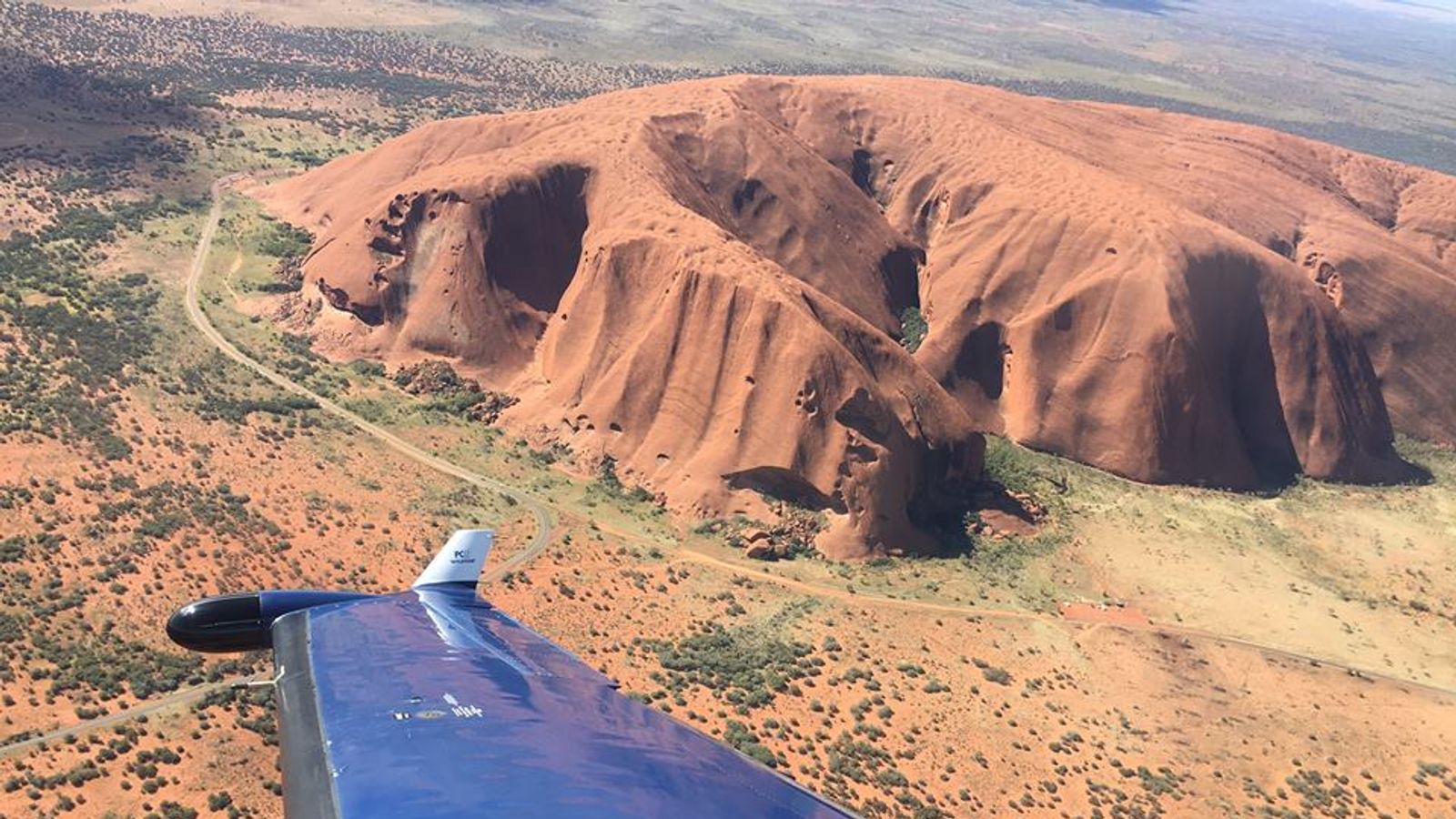 Rescuers abseil 1,000ft to rescue men trapped in Uluru crevasse | World ...