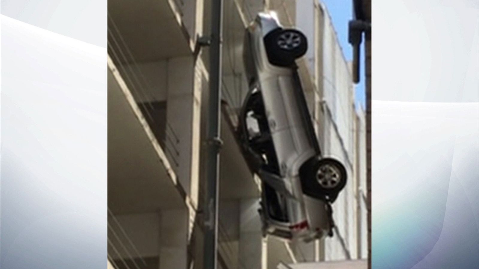 Driver's narrow escape from dangling car | Offbeat News | Sky News