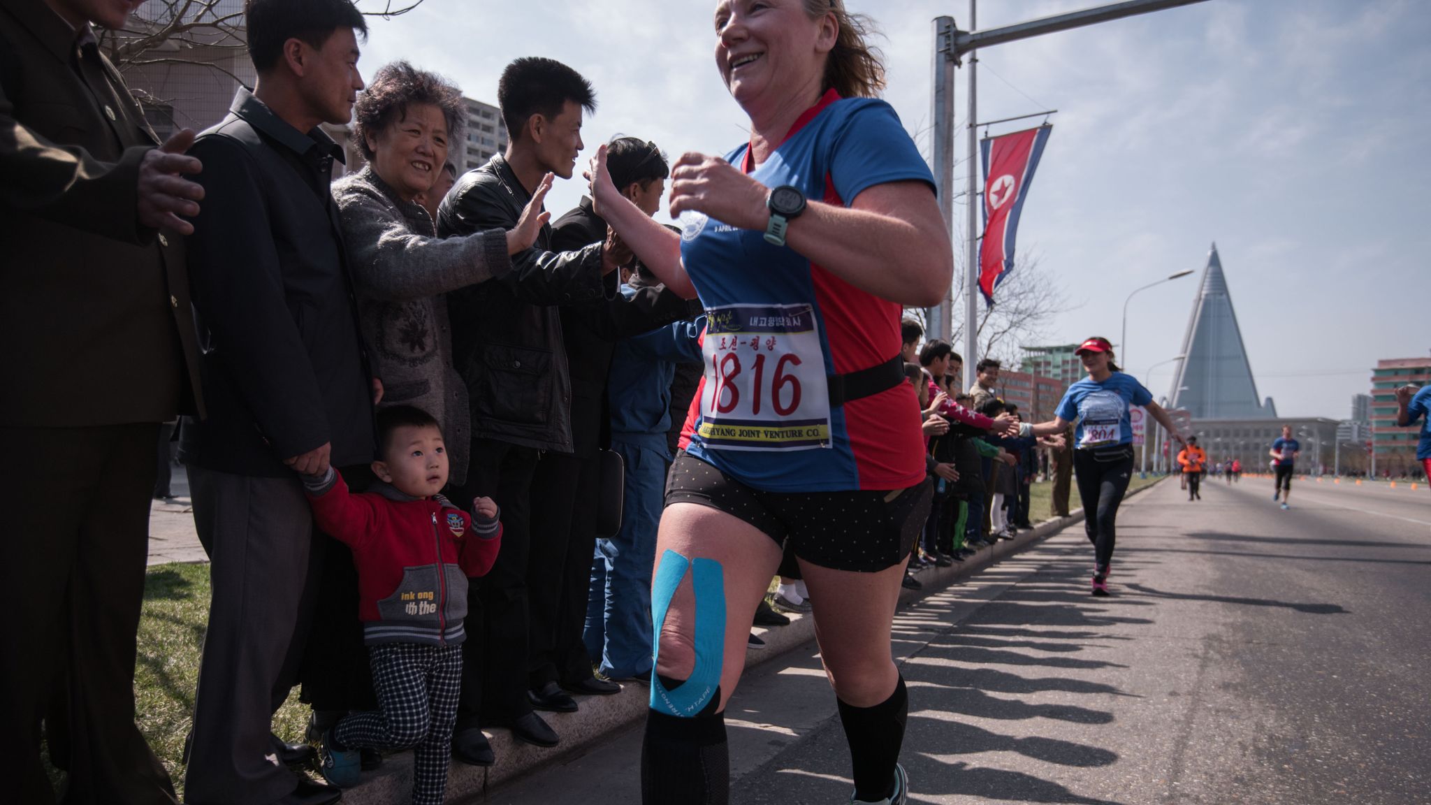 North Koreans high five foreign runners competing in Pyongyang marathon ...