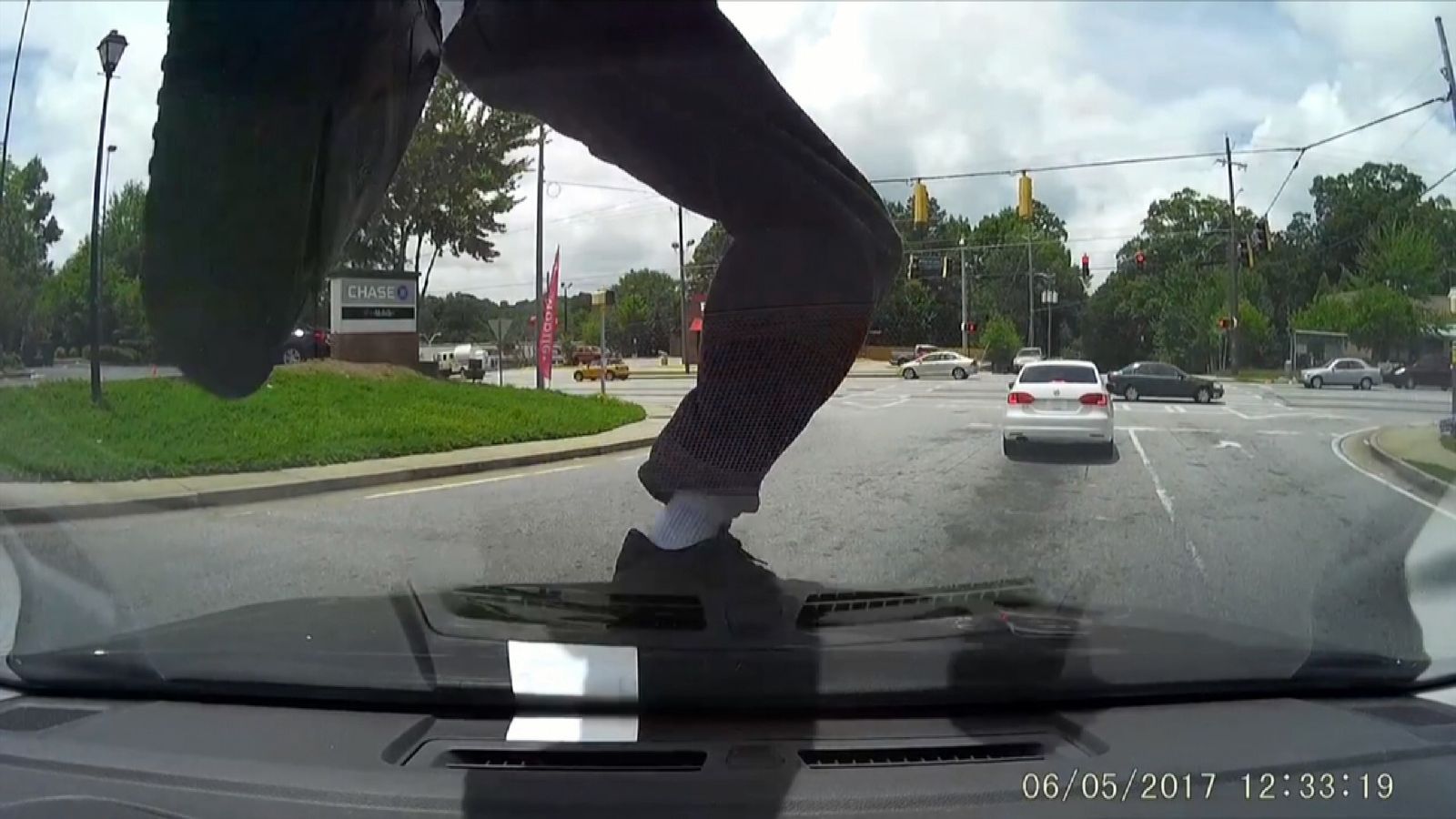 Man kicks in windscreen of moving car | World News | Sky News