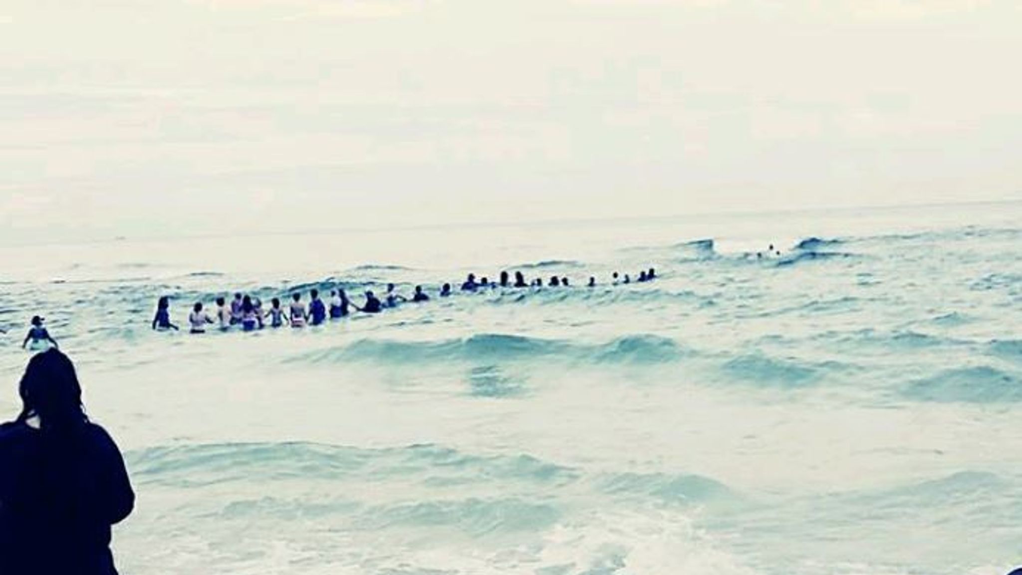 Family saved from drowning by human chain | World News | Sky News
