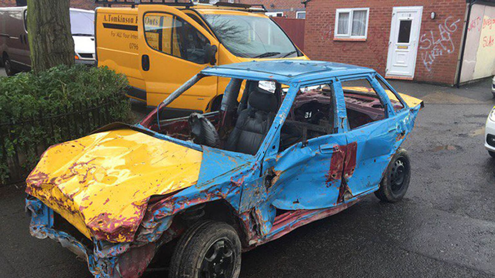 Rolling wreck: Battered car with no windows, plates or mirrors pulled ...