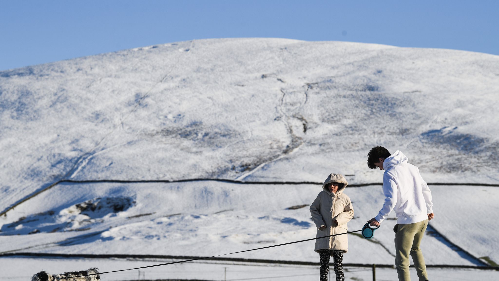 Snow falls on icy UK, causing treacherous conditions and travel ...