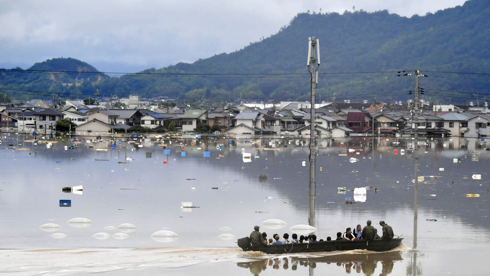 Japan's 'race against time' to save flood victims after dozens die ...