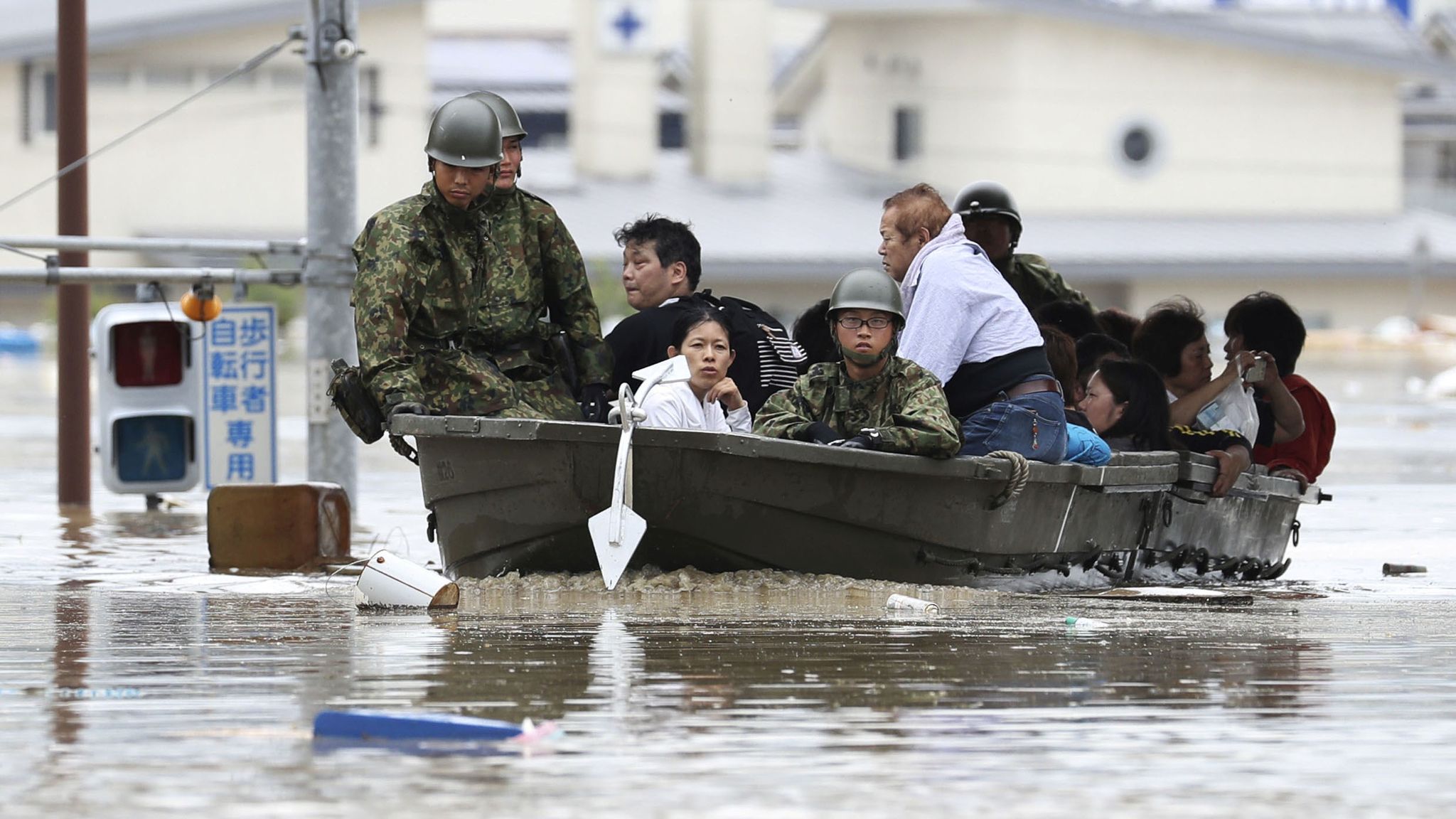Japan's 'race against time' to save flood victims after dozens die ...