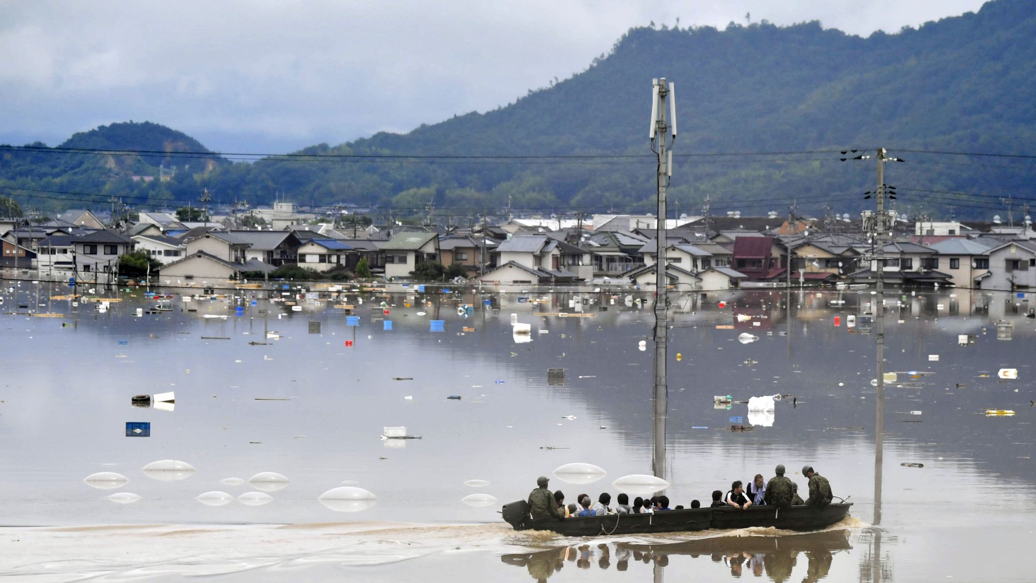 Japan's 'race against time' to save flood victims after dozens die ...