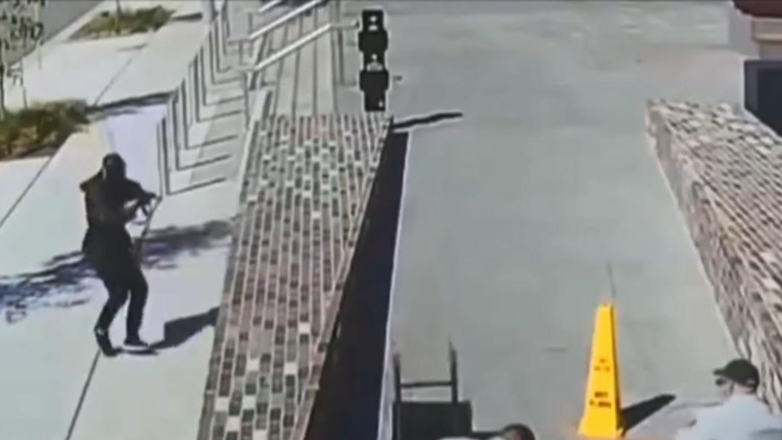 CCTV shows masked gunman robbing cash | World News | Sky News