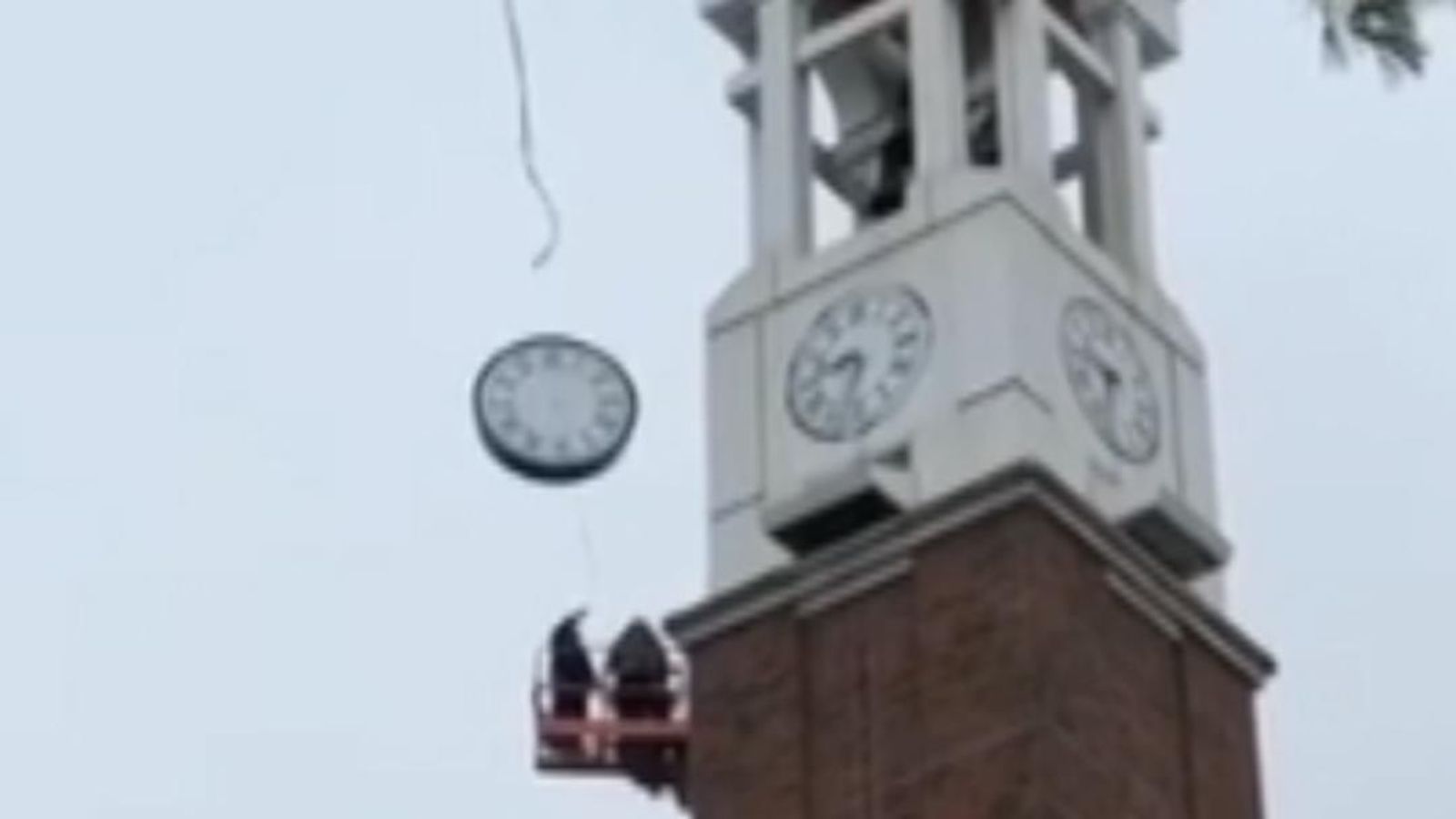 In the wrong place at the wrong time - clock face falls near workers ...