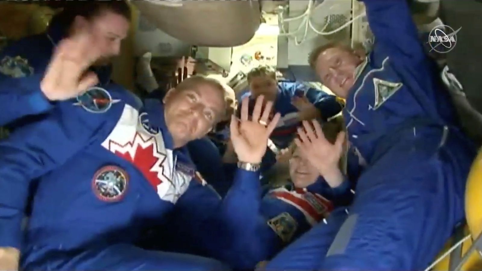 Astronauts wave aboard the ISS after spending eight hours in a tiny ...
