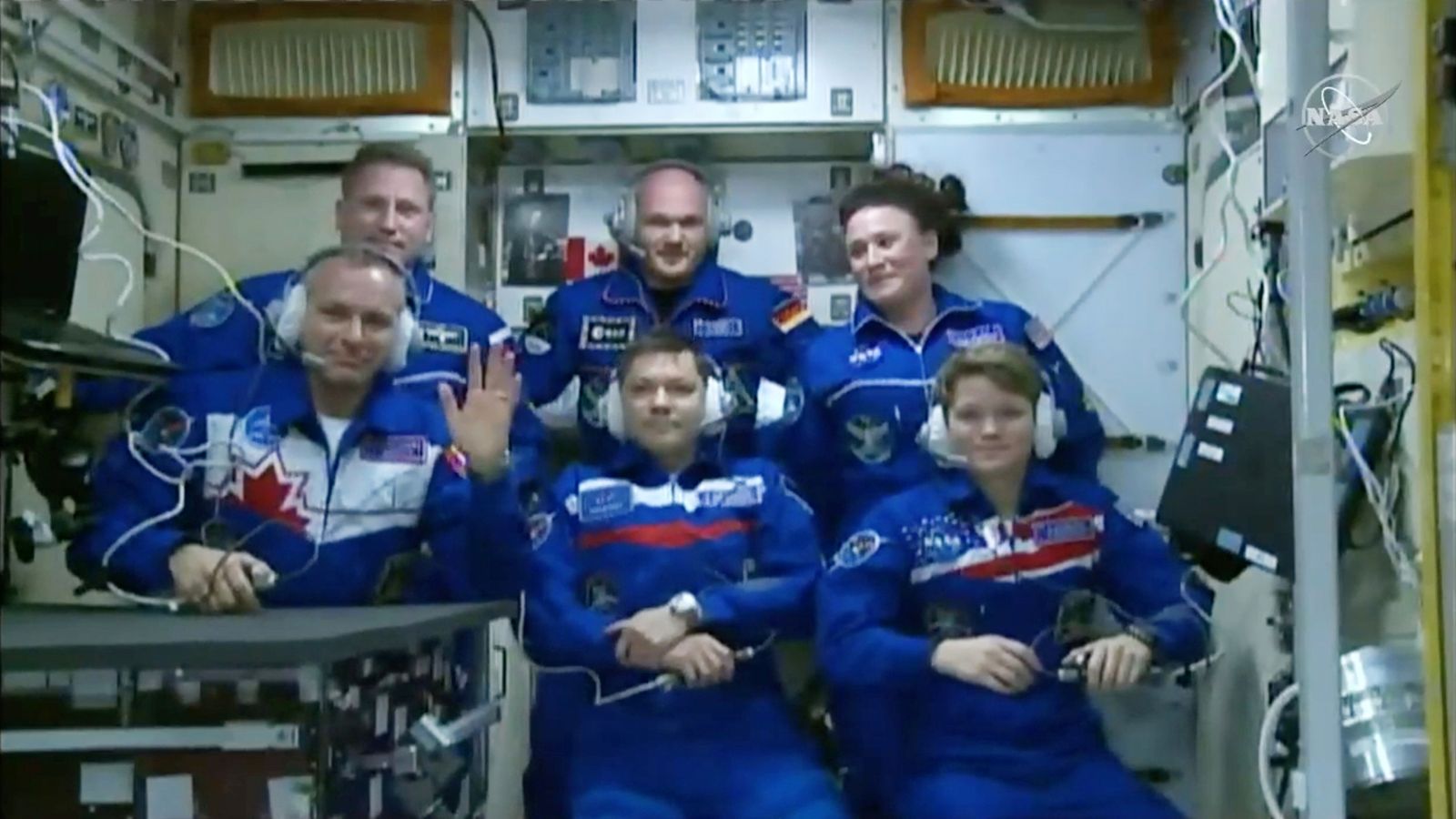 Astronauts wave aboard the ISS after spending eight hours in a tiny ...