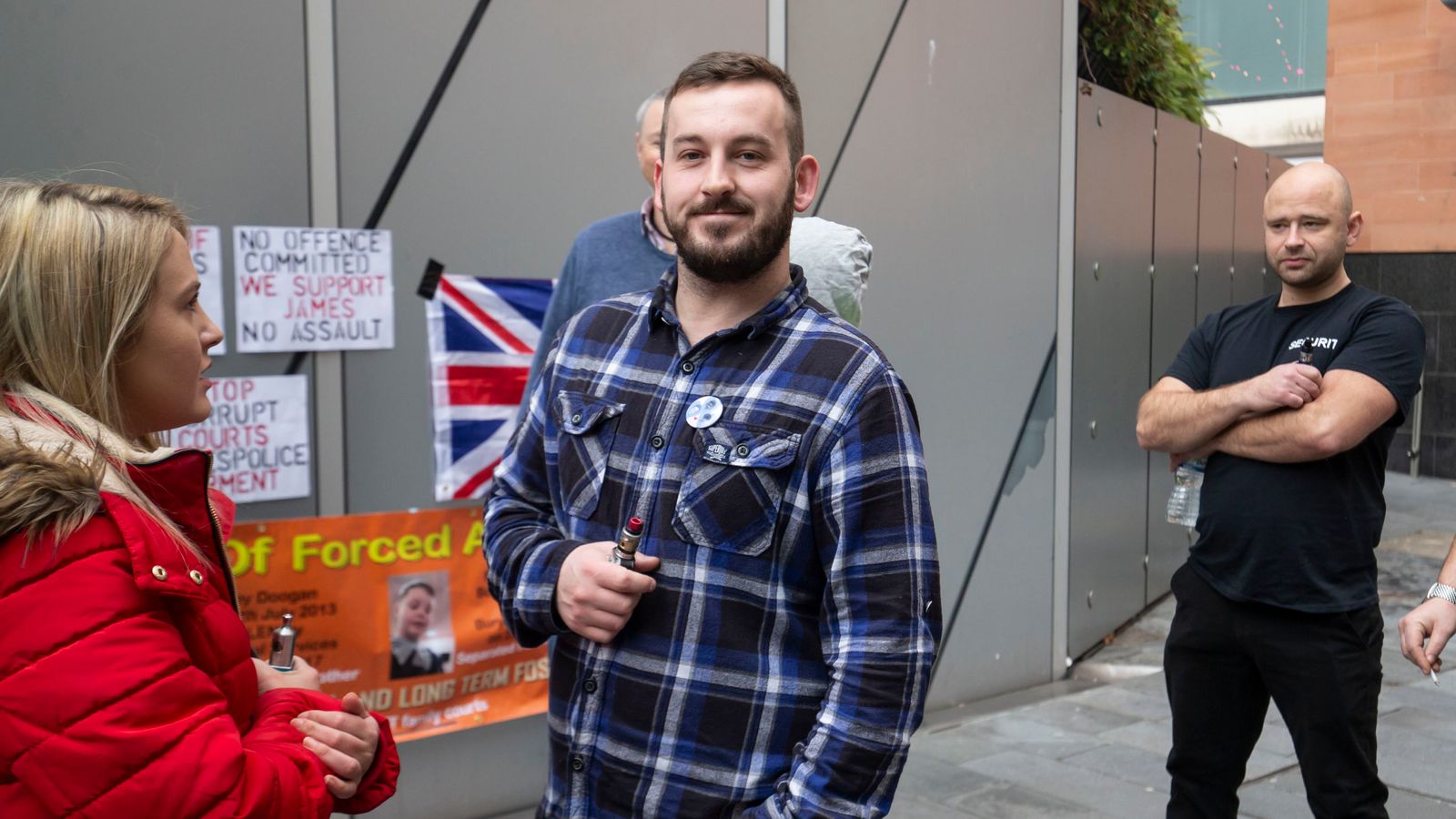 Protester James Goddard holds up sign as he is convicted of assaulting ...