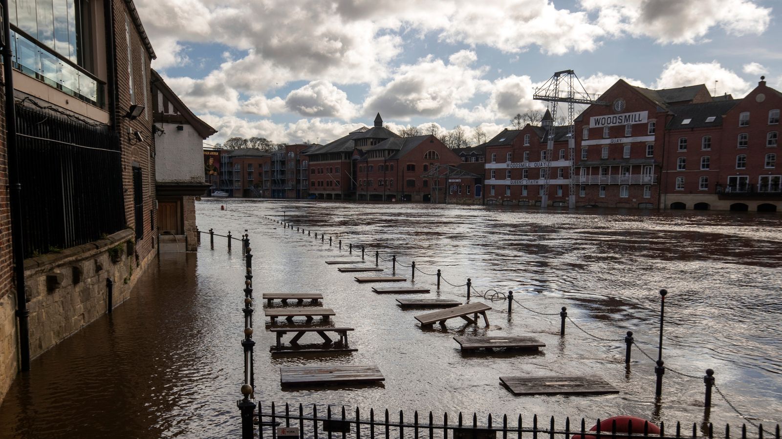 Flood defence barriers in place as heavy rainfall sparks rising river ...