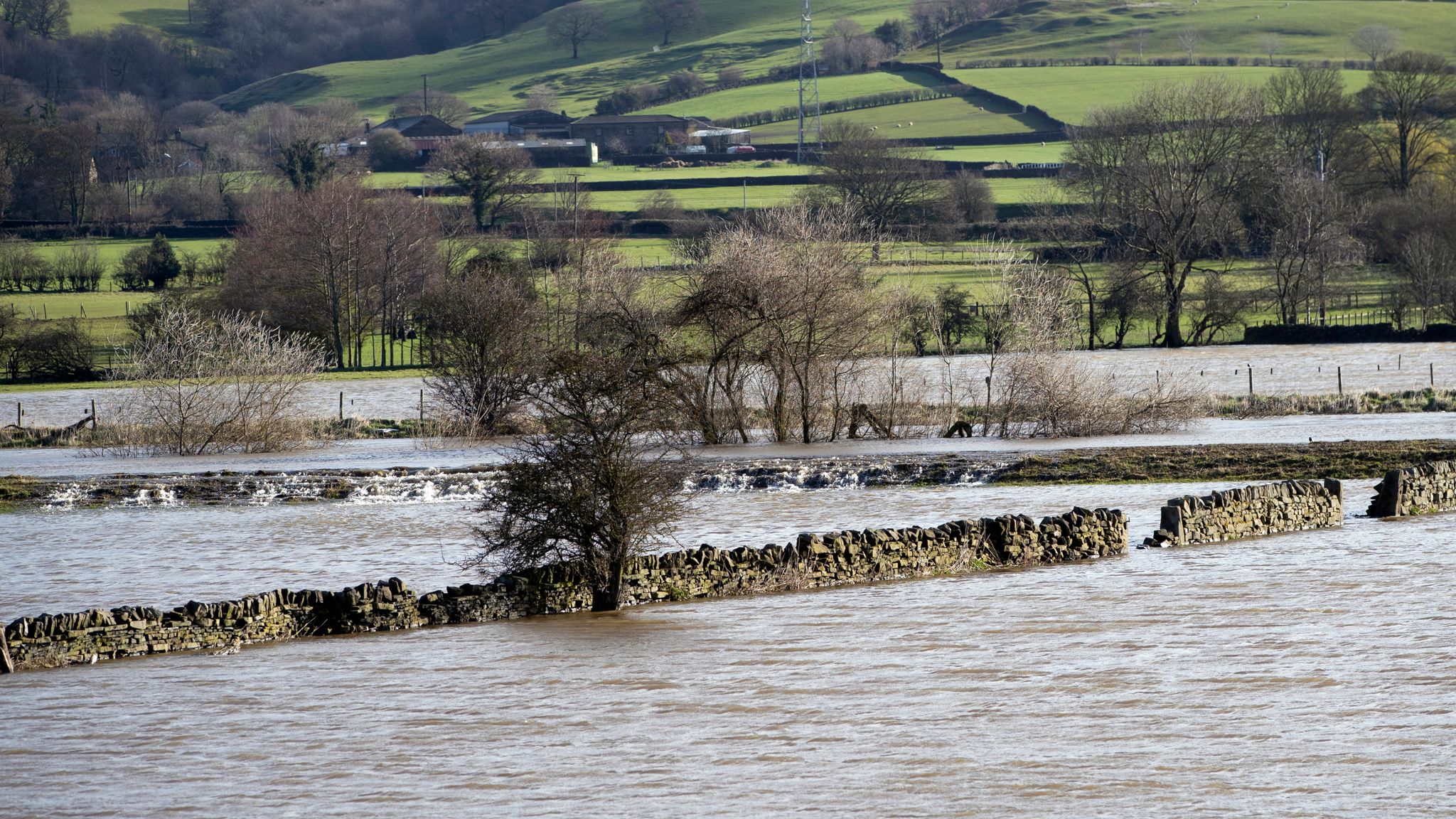 Flood defence barriers in place as heavy rainfall sparks rising river ...