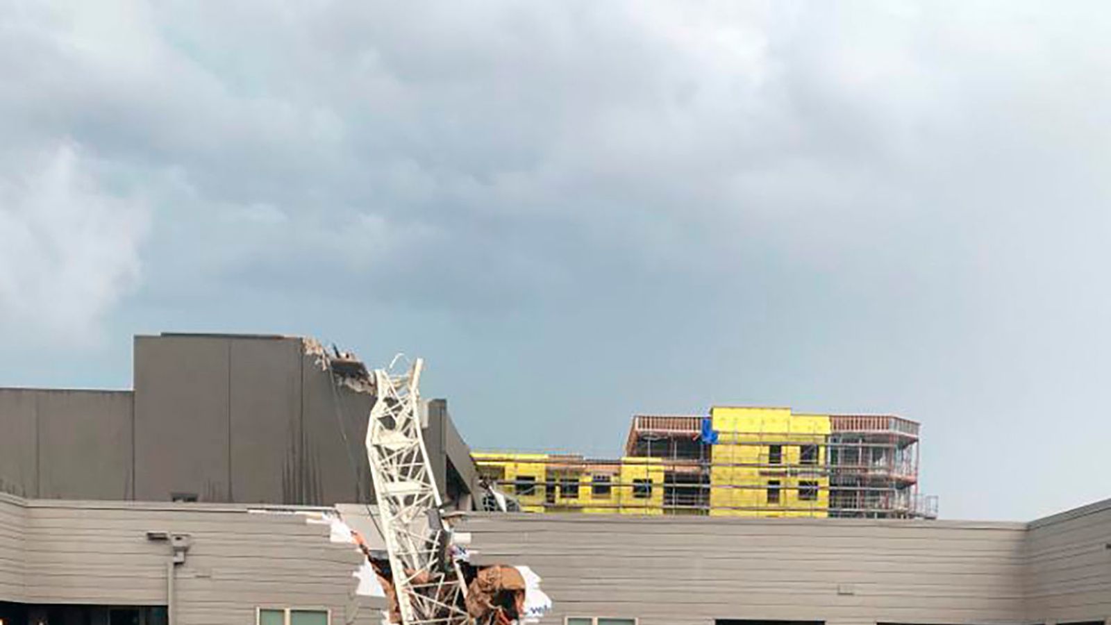Crane collapses during thunderstorm and 'slices through' apartment ...