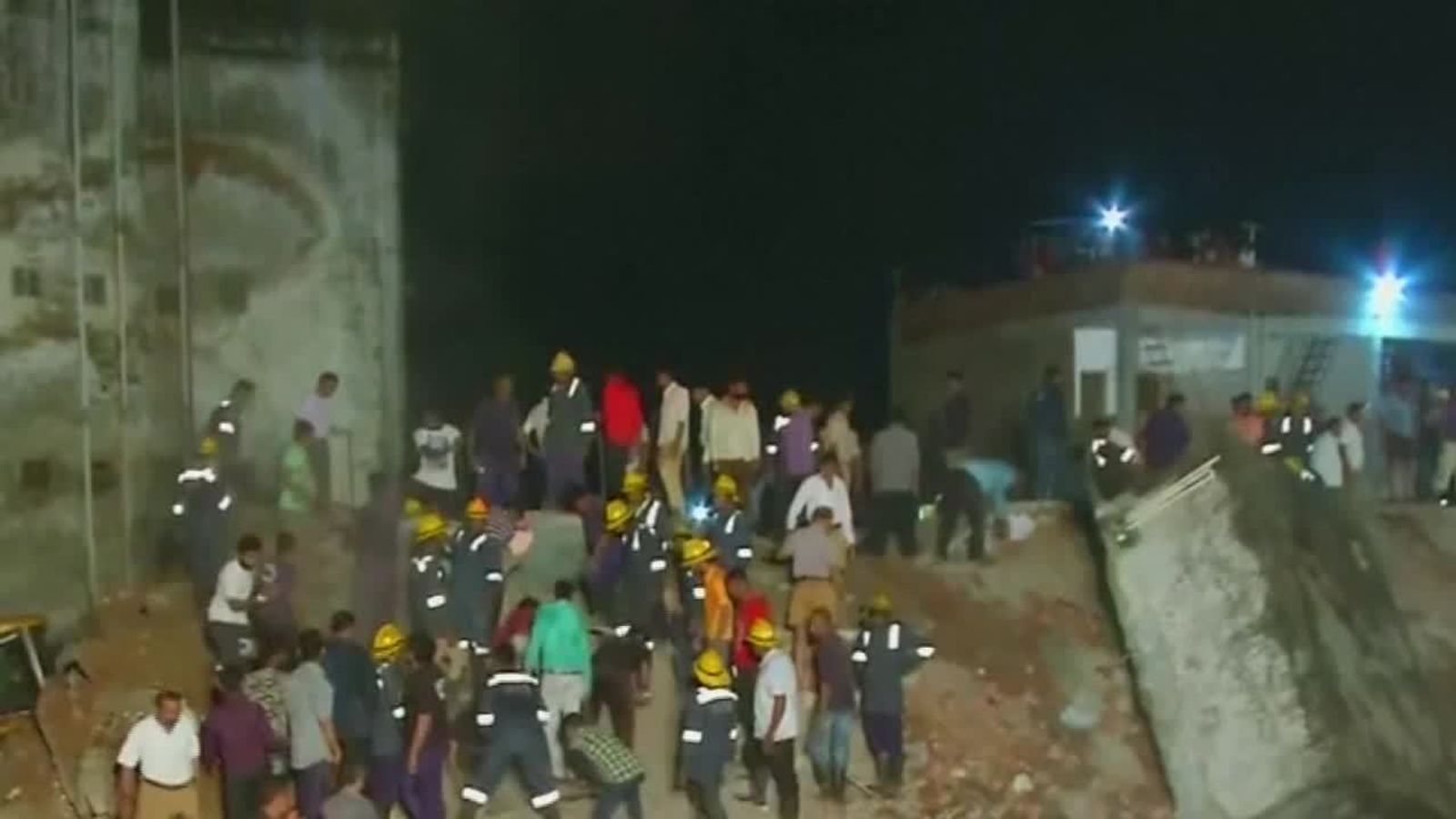 India building collapse: Residents form human chain to aid rescue ...