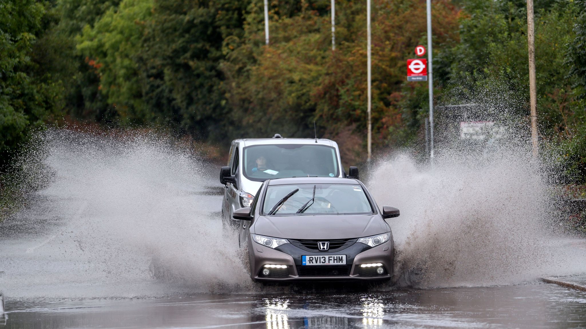 UK weather: Roads flooded and trains cancelled as heavy rain hits ...