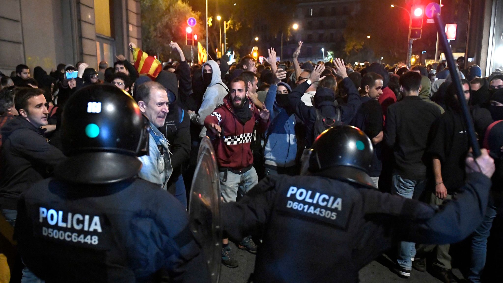 Violence as masked protesters surround police HQ in Barcelona | World ...