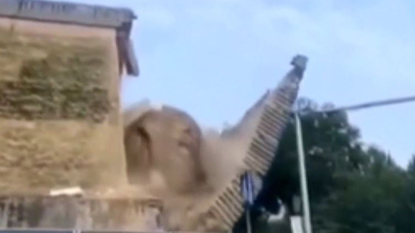 Four injured as high wall collapses into road in China | World News ...