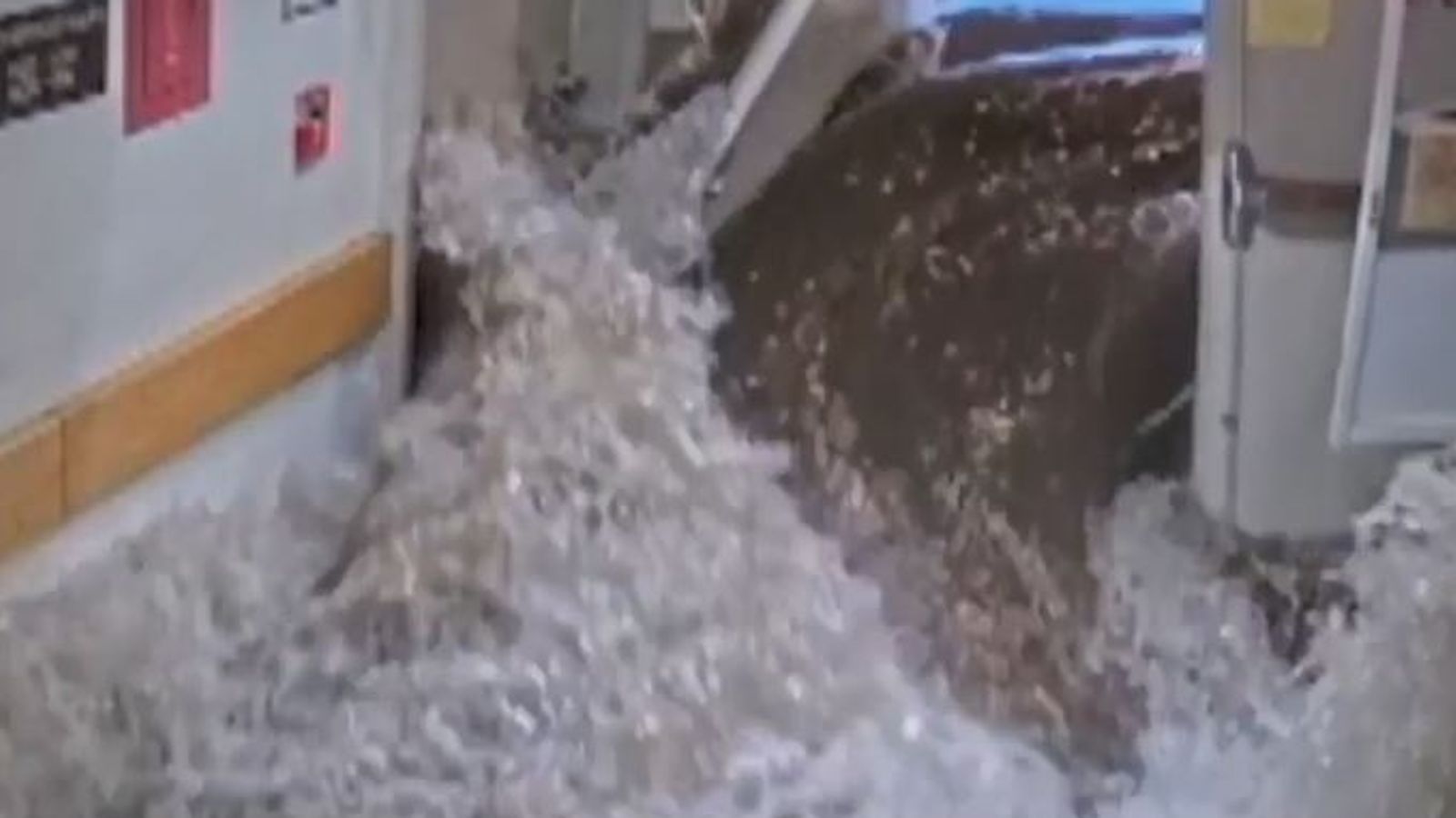 CCTV: Deluge blasts doors off hospital basement as flood fills room ...