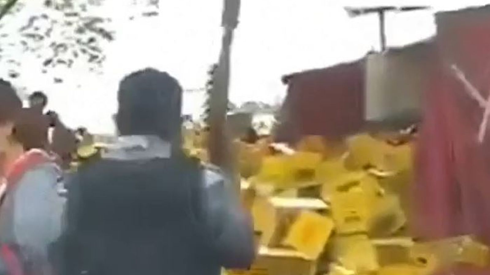'Hands off the beer!' Police fire warning shots at looters as truck ...