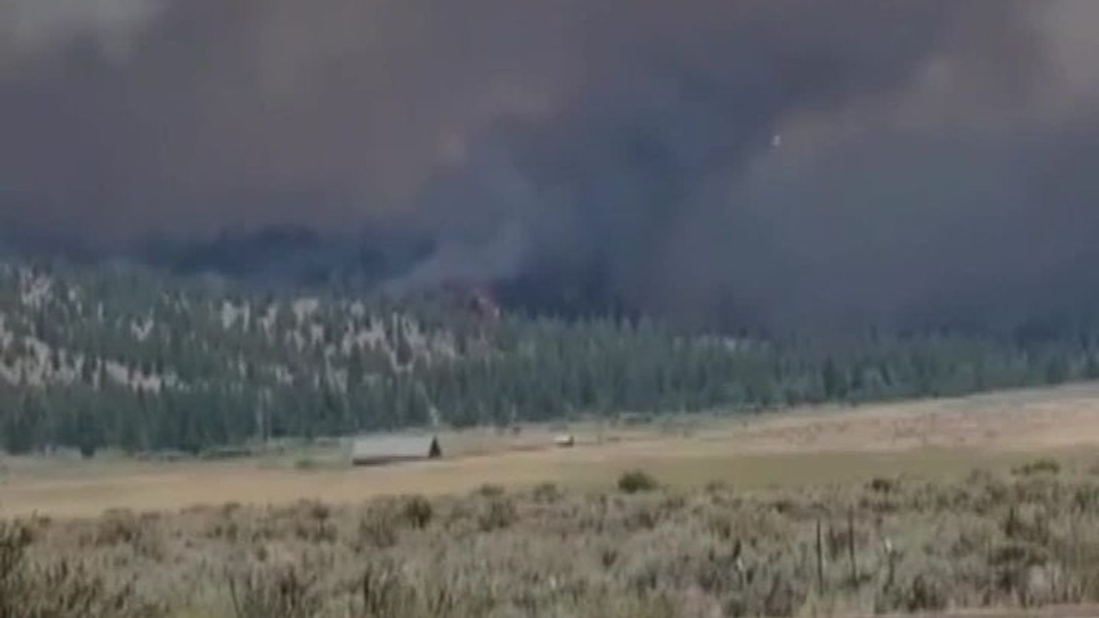 US wildfire smoke looms over horizon as evacuation is ordered | Sky News