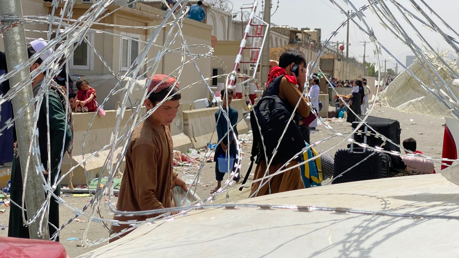 Afghanistan: Desperate women throw babies over razor wire at compound ...