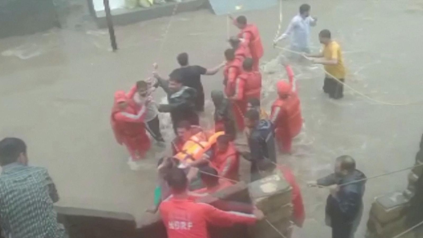 India floods: Rescuers carry people to safety over raging floodwaters ...