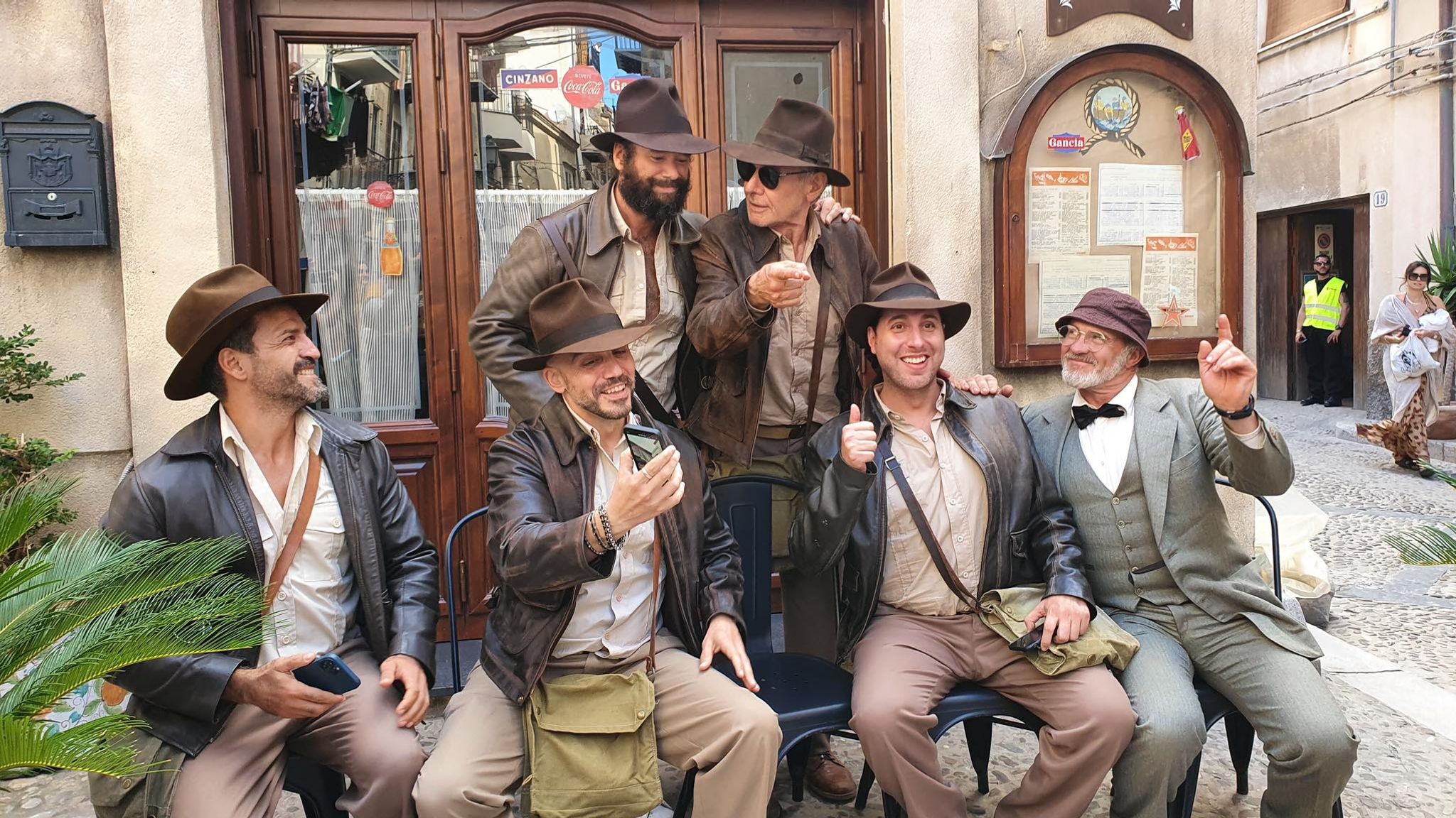 Harrison Ford poses as Indiana Jones with lookalike fans dressed as the ...