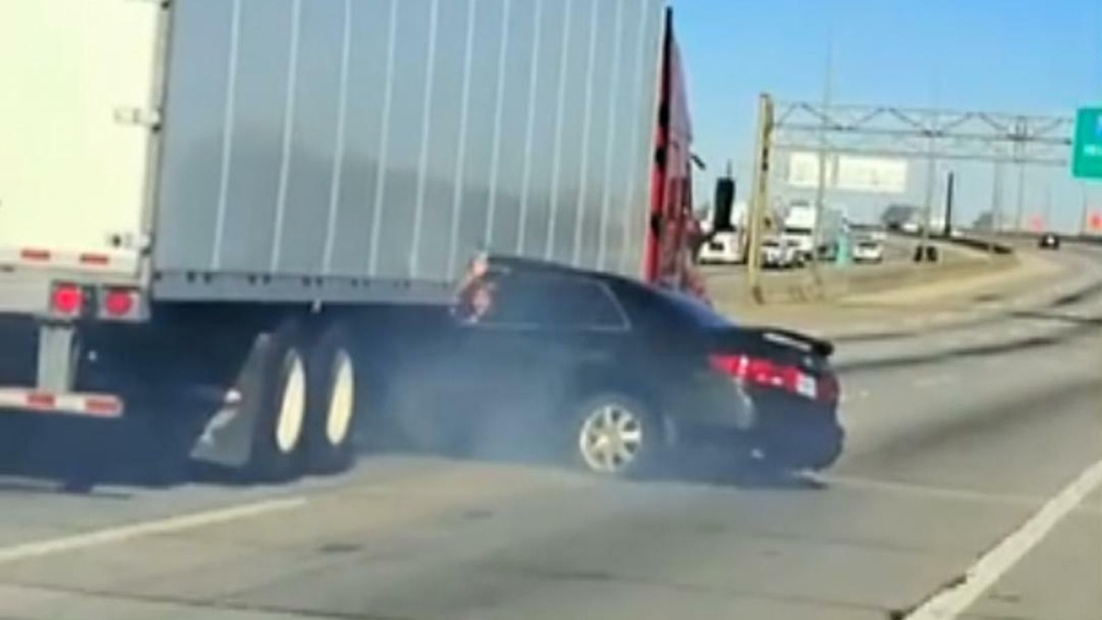 Video: Miracle injury escape as car pinned under moving lorry on ...
