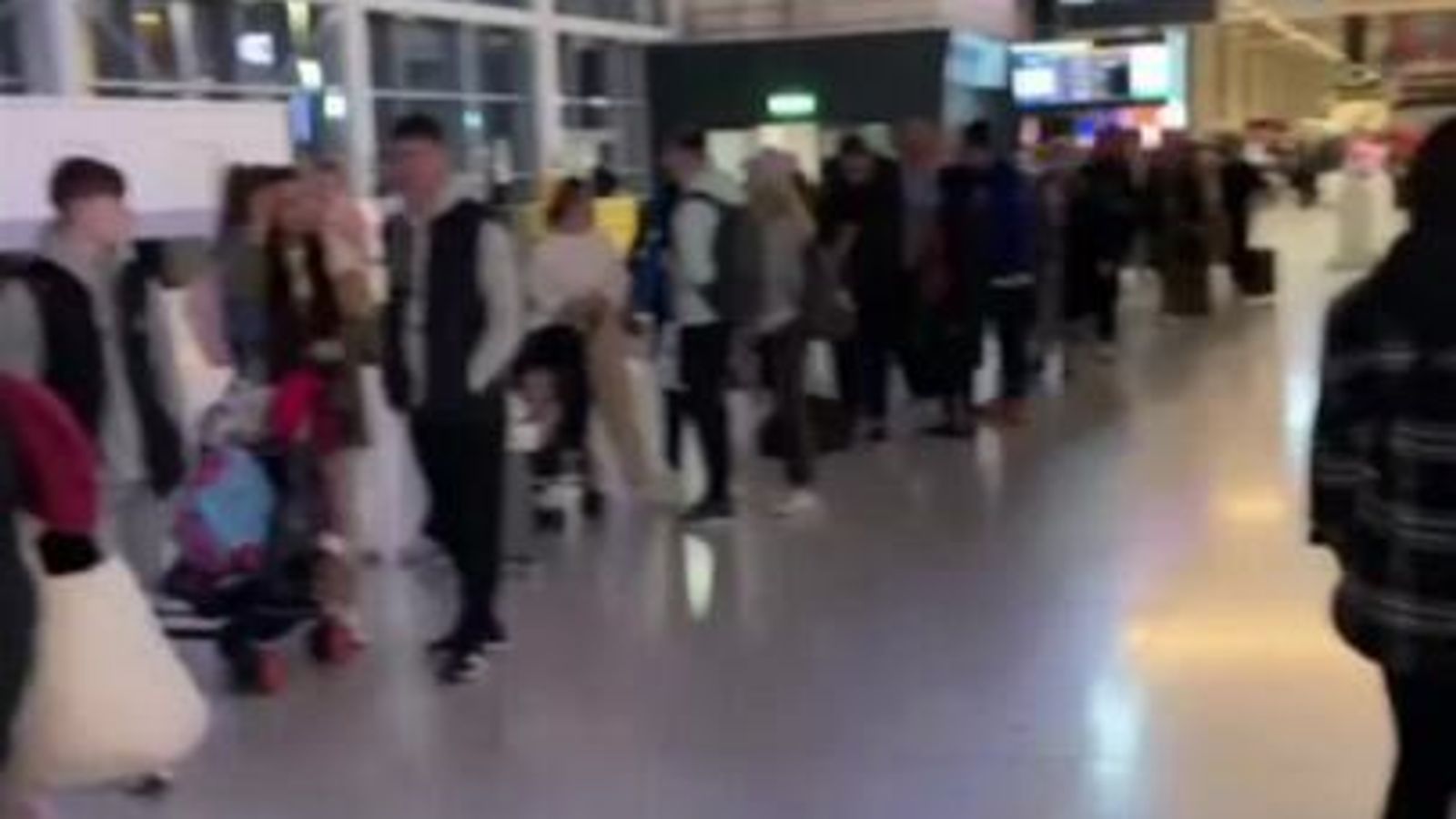 Passengers queue at Manchester Airport as COVID-19 causes staffing ...