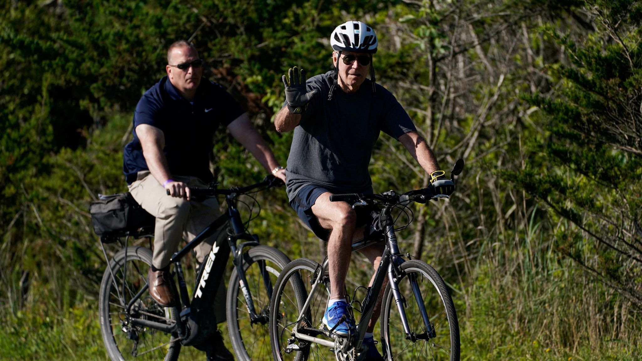 Joe Biden falls while getting off his bike after getting his 'foot ...