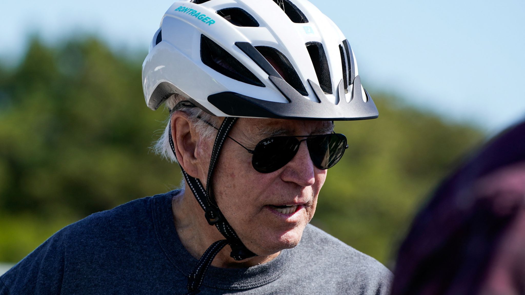 Joe Biden falls while getting off his bike after getting his 'foot ...