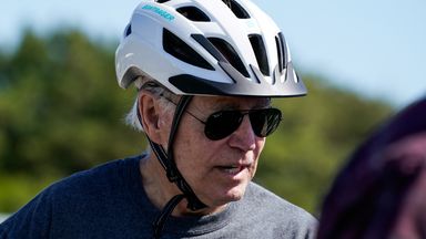 Joe Biden falls while getting off his bike after getting his 'foot ...