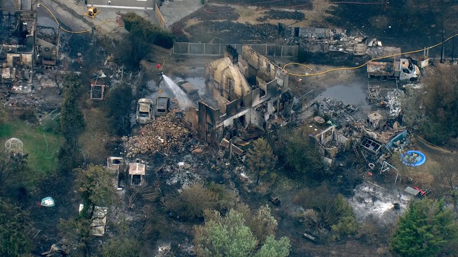 Homes still smouldering after heatwave fires in Wennington, Greater ...