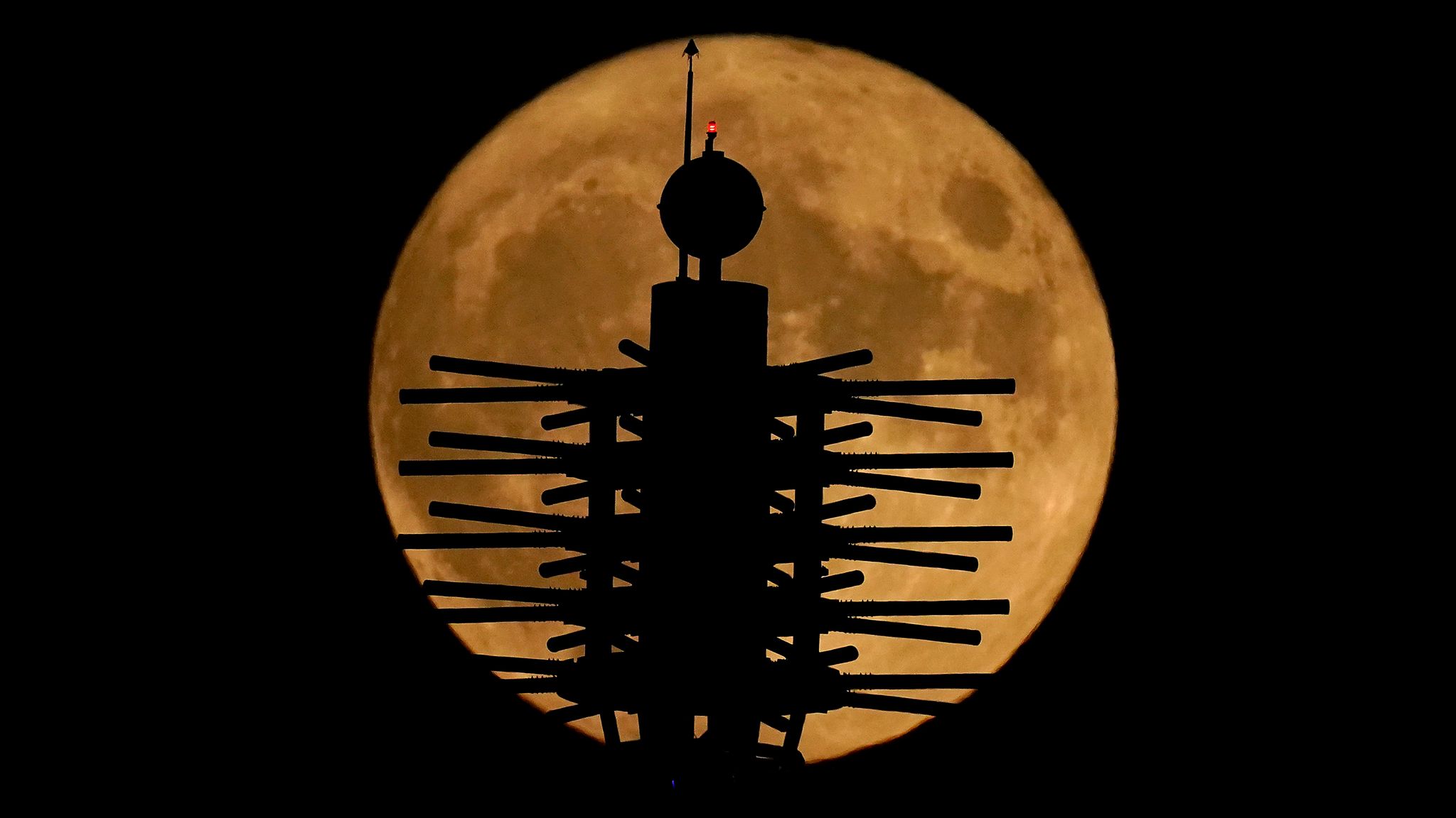 In pictures: Glowing supermoon delights stargazers across the UK and ...