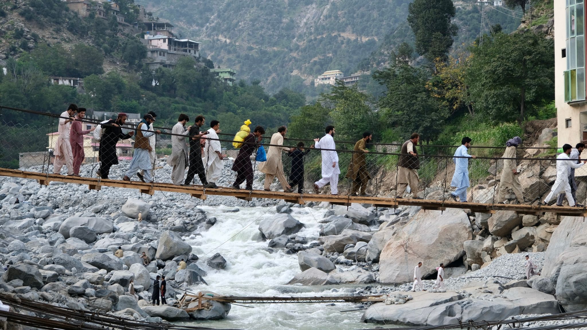 Pakistan floods: Men trek 20 miles from cut-off town to get food for ...
