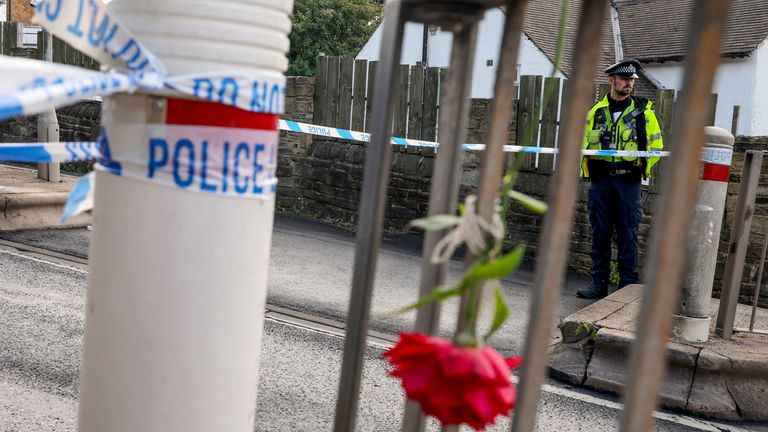Police cordon and floral tributes near the scene in Woodhouse Hill ...