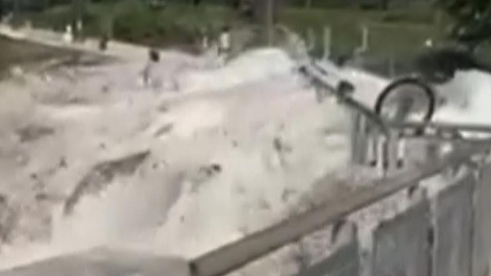 Giant wave sweeps people and debris away over rocks | Sky News