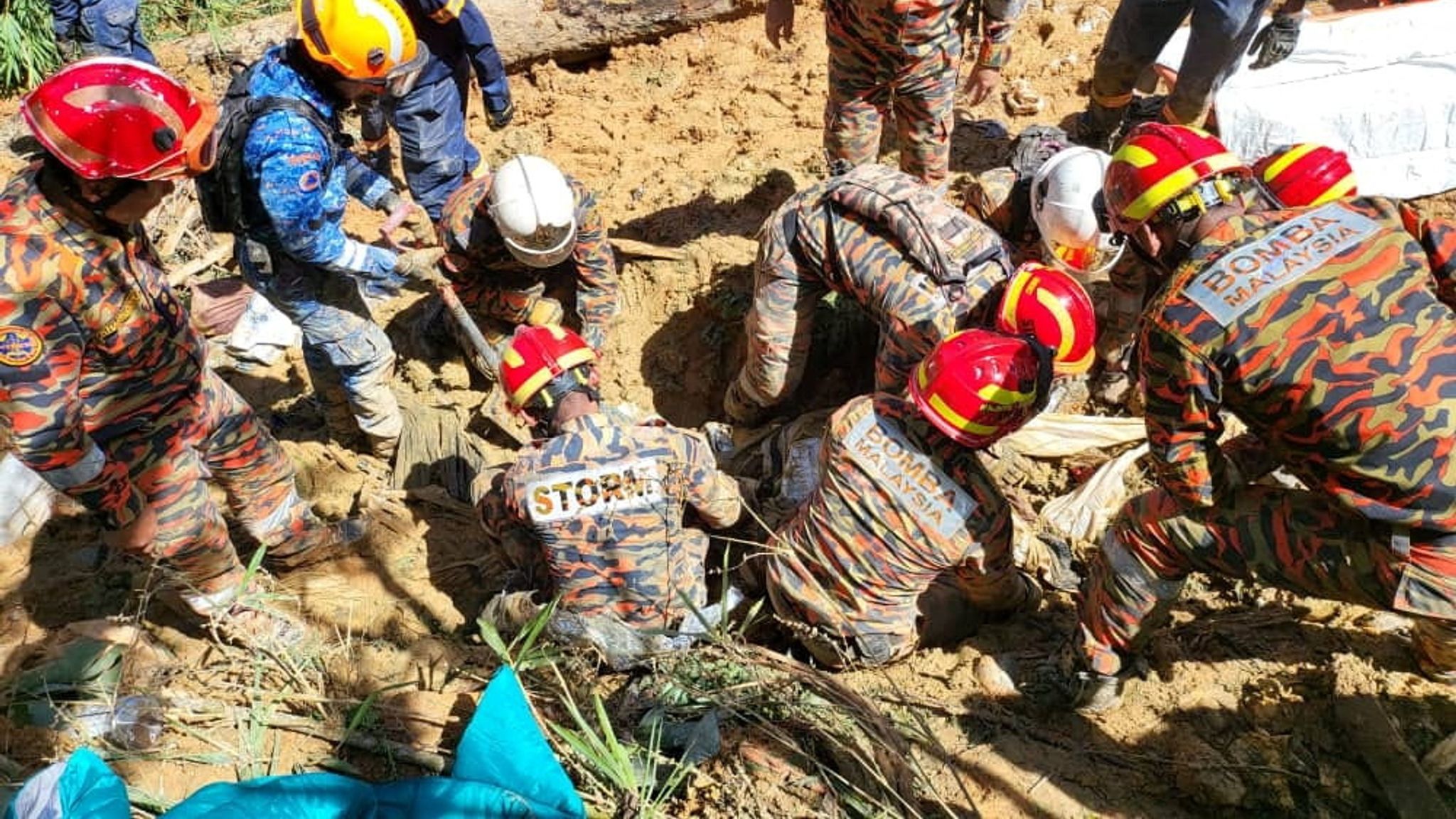 Three children among 18 killed in Malaysian landslide as rescuers dig ...