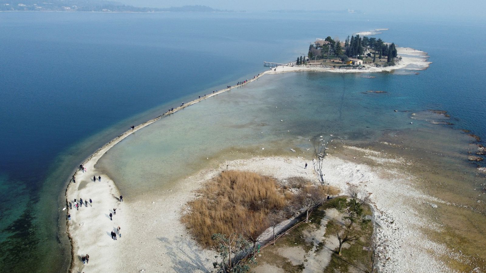 Italy drought exposes walkway on Lake Garda and Venice canals dry up ...