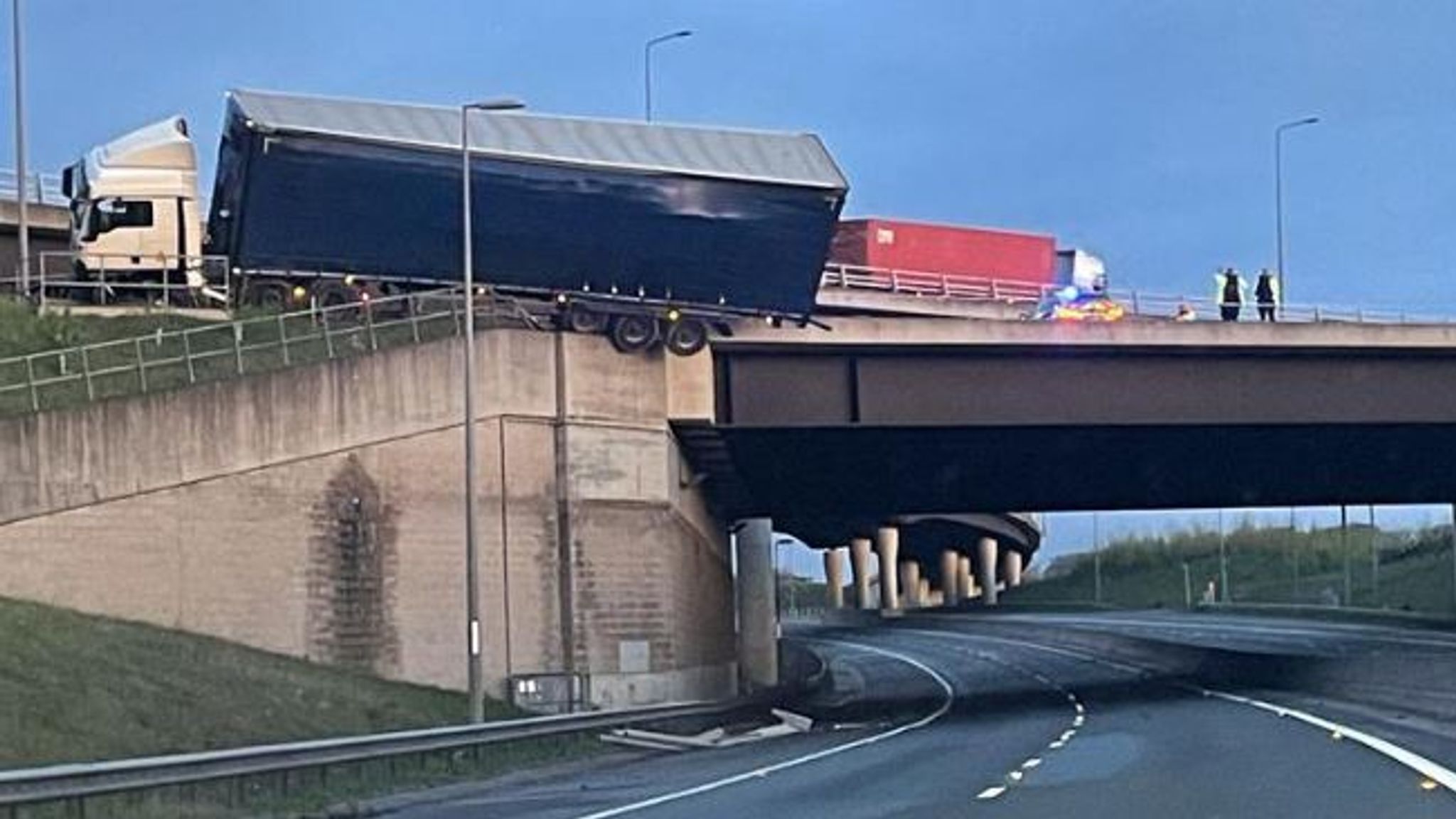 Lorry left hanging off bridge after M1 crash forces closure of major ...