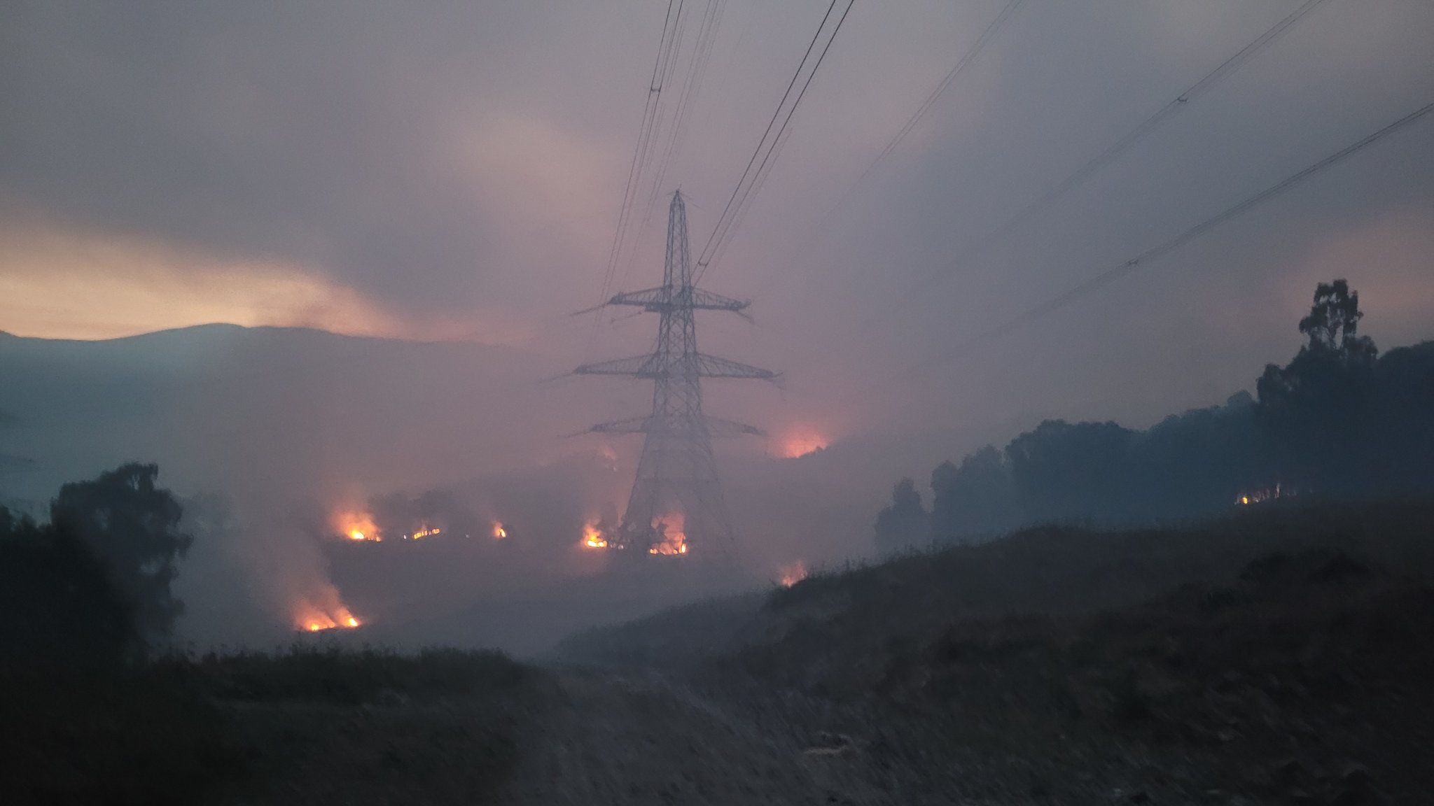 Two firefighters airlifted to hospital as crews battle wildfire near ...