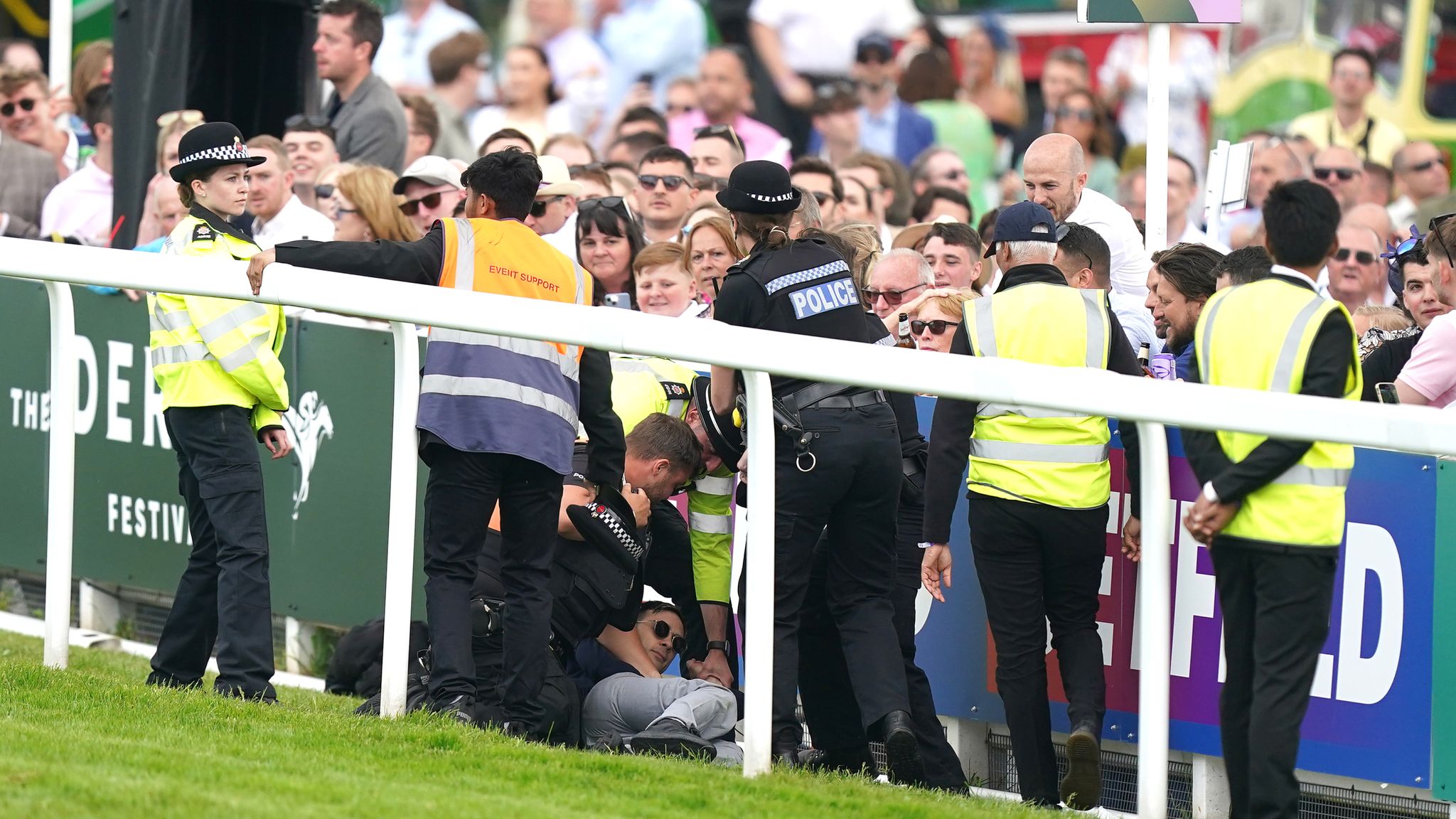 Protester runs on during horse race as 31 held over Epsom Derby ...