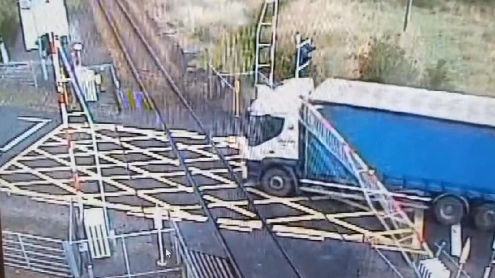 Truck smashes through barriers at level crossing causing rail delays ...