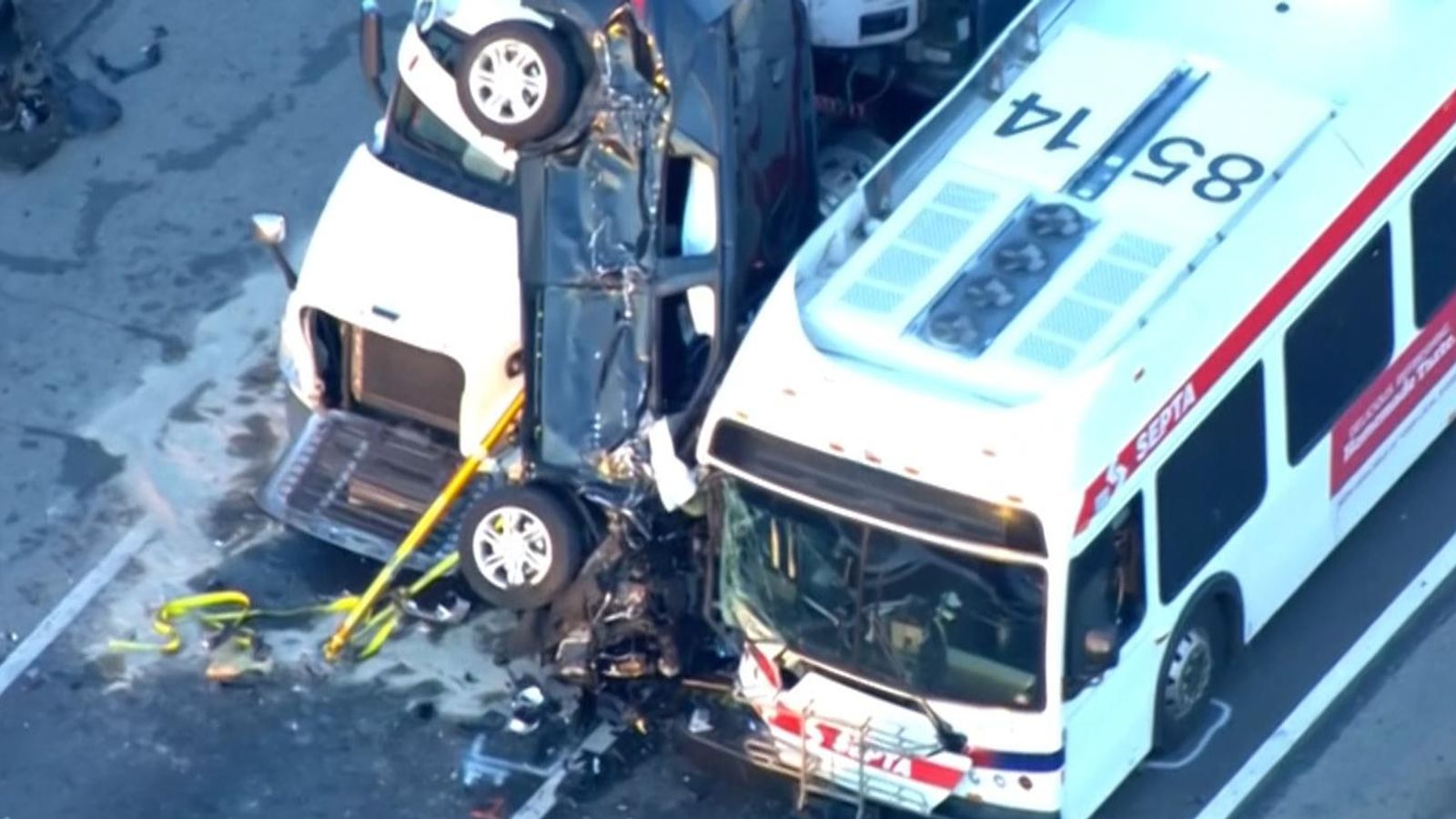 US: Crash leaves car wedged between bus and lorry and four people with ...