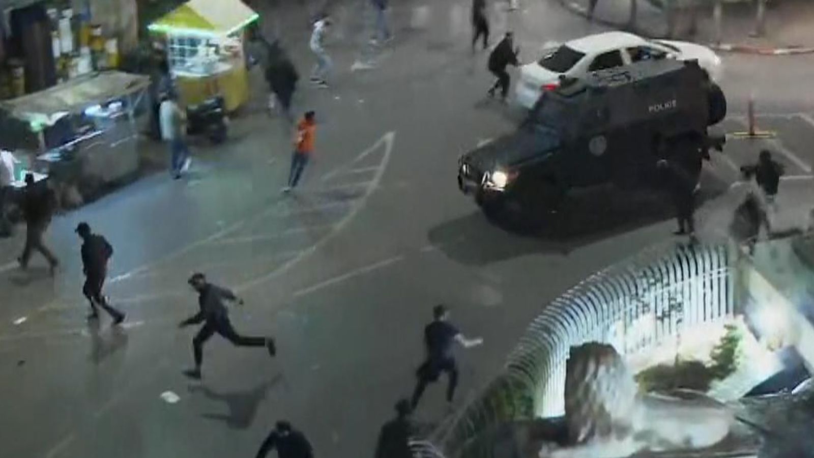 Israel-Hamas war: Protesters dodge a police car driving around a ...