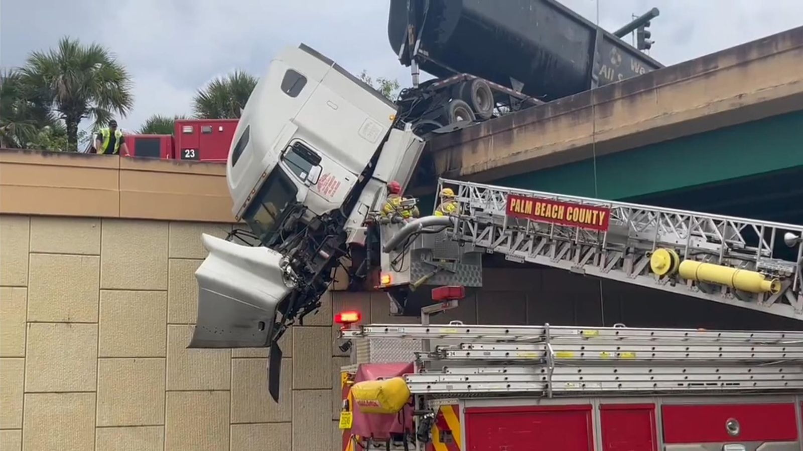 Florida firefighters rescue driver from truck hanging off overpass ...
