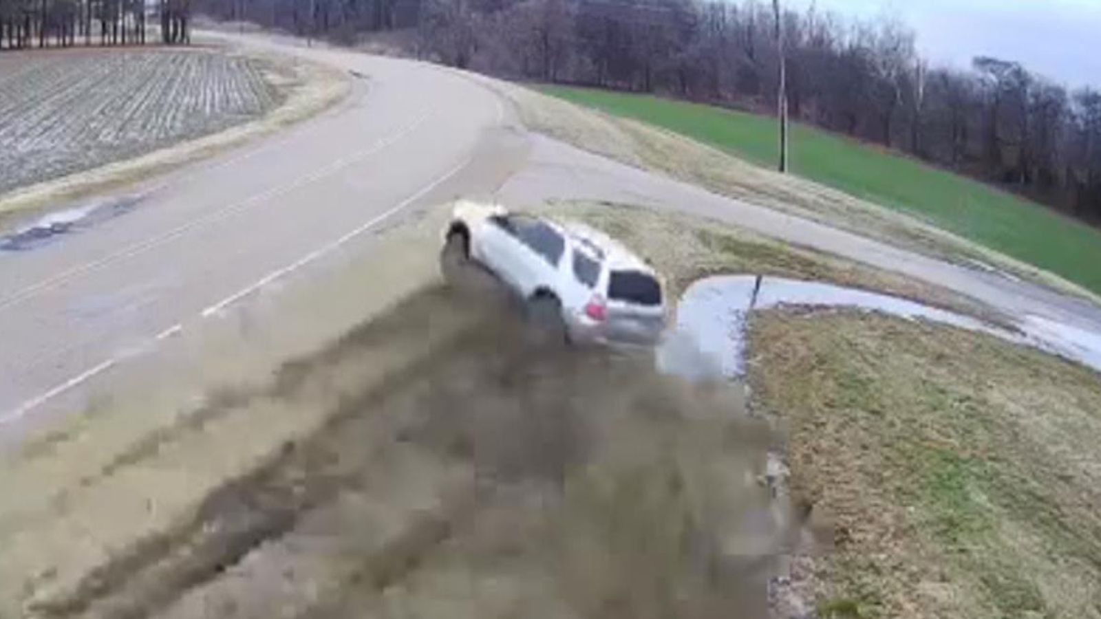 US: Security camera footage catches moment car skids off the road, slamming into utility pole in ...