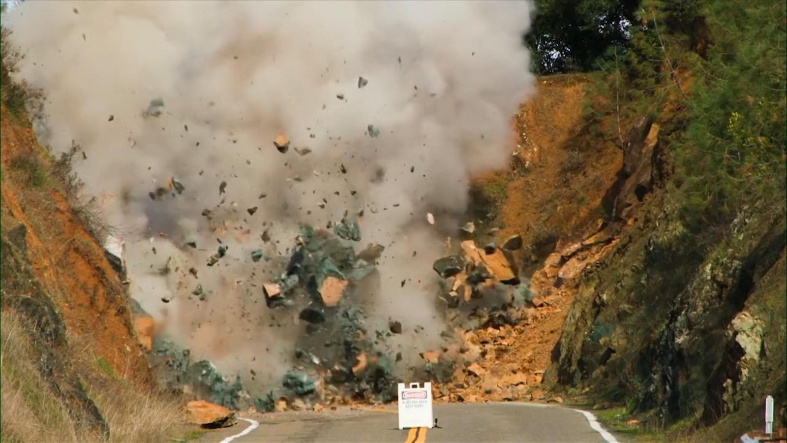 Crews blast boulders to clear road after mud and rock slide in California | News UK Video News ...